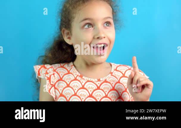 Smiling happy little girl showing eureka gesture. Portrait of young ...