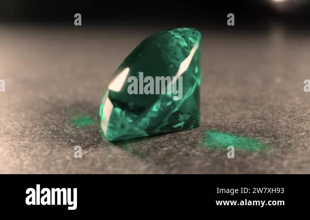 Rotating camera shots of isolated lying big green emerald. Treasure ...