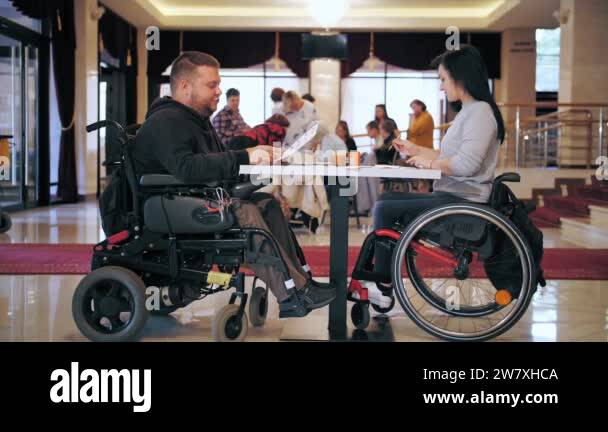 wheelchair. disability. disabled young man and woman are drawing with paints, sitting in ...