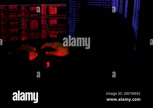 A male hacker is hacking into security systems. The programmer at the computer. Crack the ...