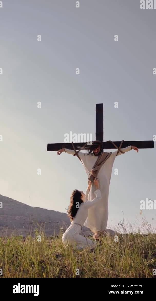 Mary mourns the death of Jesus at his feet. Jesus is crucified on the cross Stock Video Footage ...
