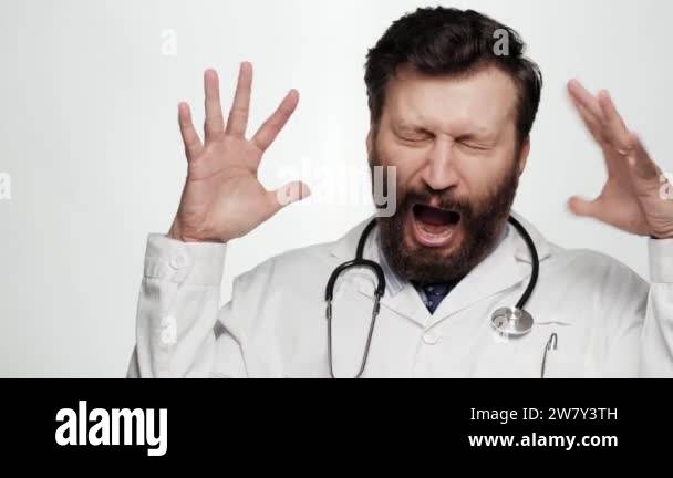 Funny crazy doctor is scared, terrified. Frightened man doctor on white ...