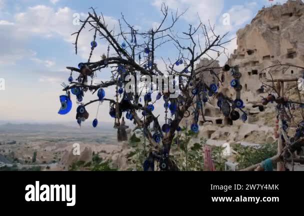 large groups of blue bead worn against the evil eye hanging on trees in ...