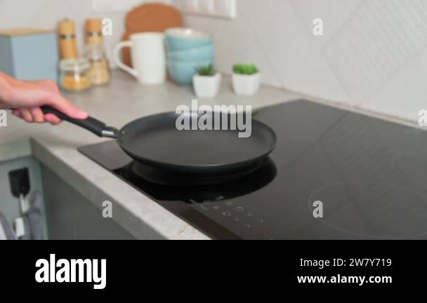 Modern kitchen appliance. Woman hand turn on induction stove to cook ...