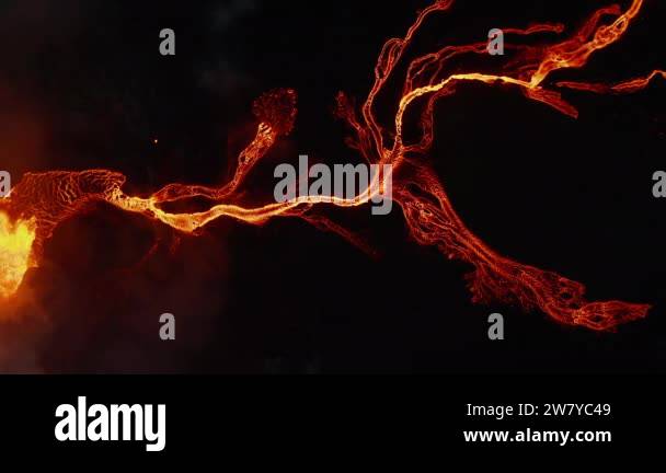 Aerial birds eye overhead top down panning view of flowing hot lava ...