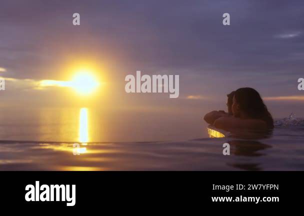 Couple Bathing in an Infinity Pool, With the Majestic View of the Ocean ...