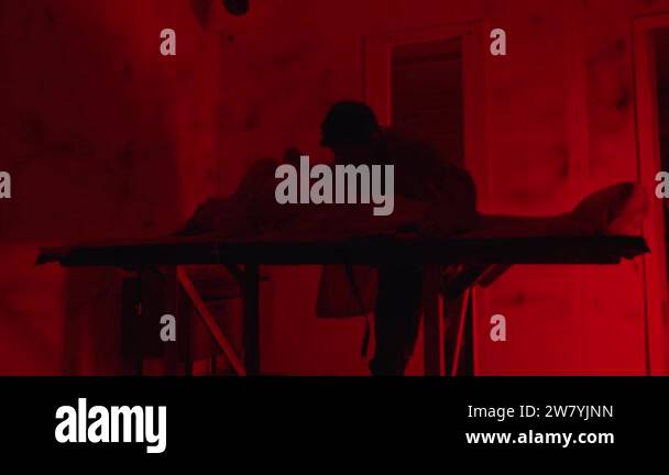 Horror acting - the doctor ties the mad girl to the table in the bloody ...