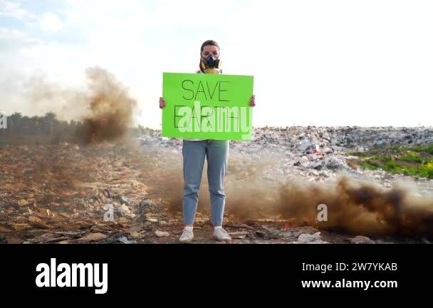 young woman activist with a poster in hands save earth stands middle of ...