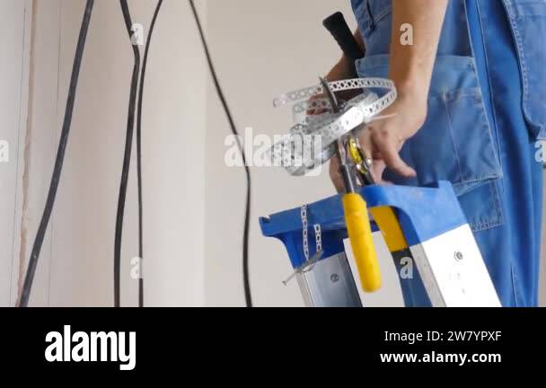 Installation of electrical wiring on apartment ceiling and wall ...