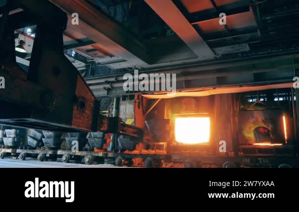 Foundry furnace with industrial mechanism loading metal into it Stock ...