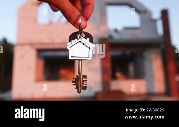 Hand with the key to the future house on the background of a ...