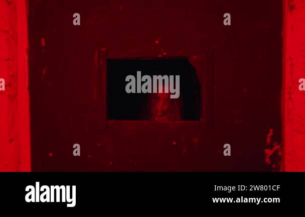 Horror acting - a woman in a straitjacket standing behind the door in ...