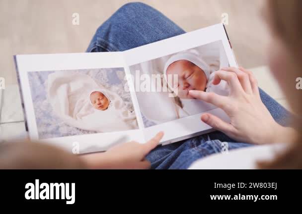 top view. mother and daughter watch photobook from discharge of newborn baby Stock Video Footage ...
