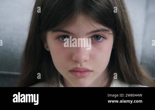 portrait of a sad beautiful girl with blue eyes and tears on her cheeks ...