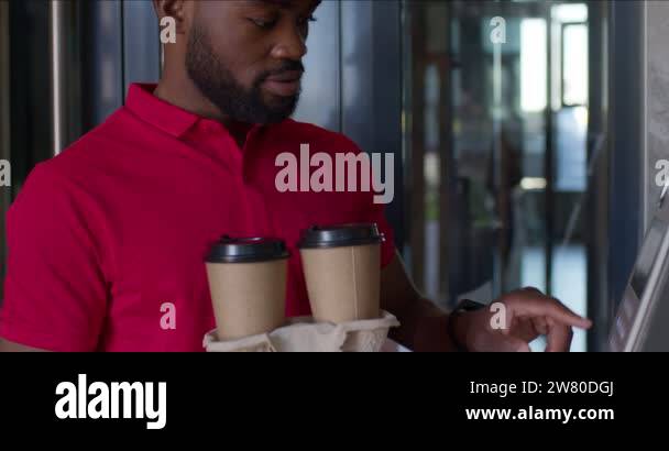 Delivery african man doing fast food delivery, dials the house number ...