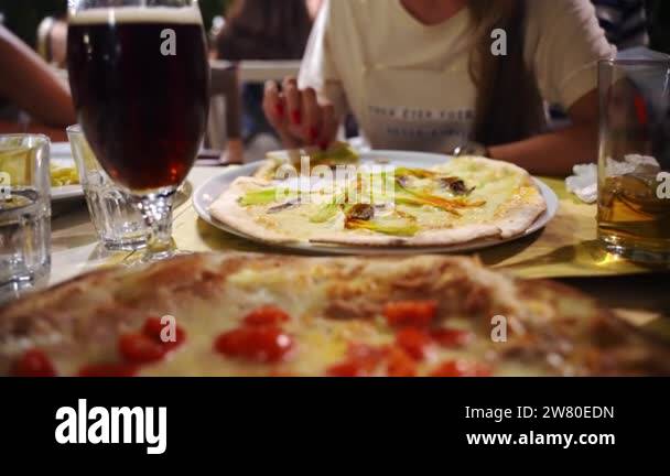Unrecognisable woman tasting juicy Italian pizza with melting cheese ...