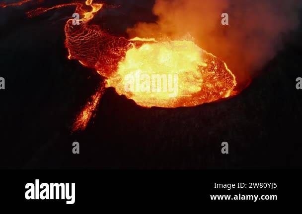 Crane down footage of boiling magma in erupting volcano crater. Lava ...