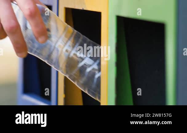 Male hand throwing plastic bottle recycling container garbage sorting ...
