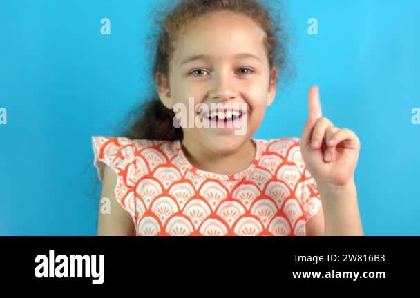 Smiling happy little girl showing eureka gesture. Portrait of young ...