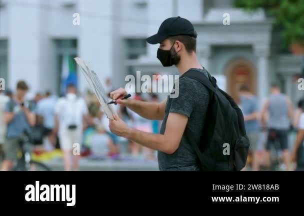 Masked person on riot. Rally activist man drawing poster sign, poster ...