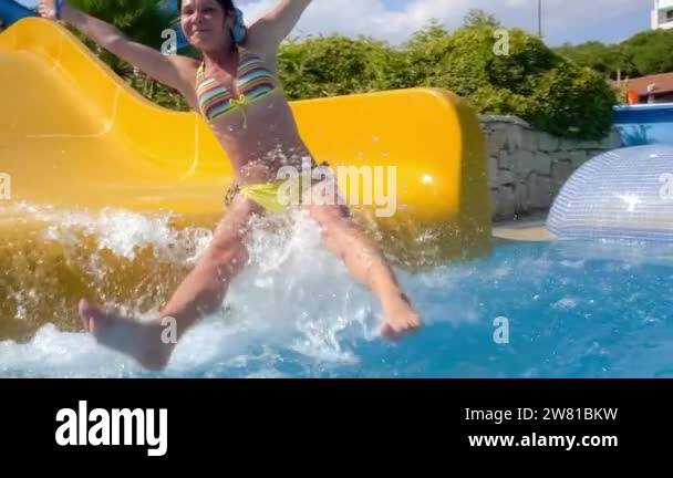 Descent from the waterslide on holiday aqua park. Slow motion on a ...