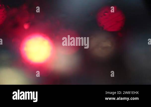 Rain falling on car windshield view. Drive car on traffic jam street at ...