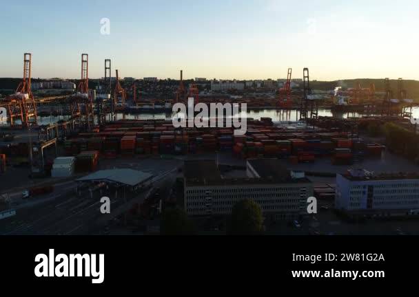 Aerial view of modern container port docks at sunrise. Harbor and ...