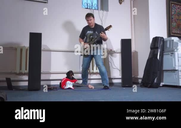 May 25, Russia, Rostov: Young man expressively plays electric guitar ...