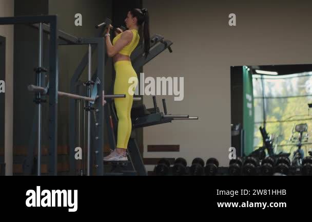 Hispanic Woman Does Pull-Ups On Gravitron For Strengthening The ...