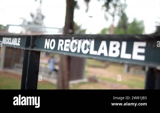 Spanish sign for recyclable and non-recyclable trash with trees as ...