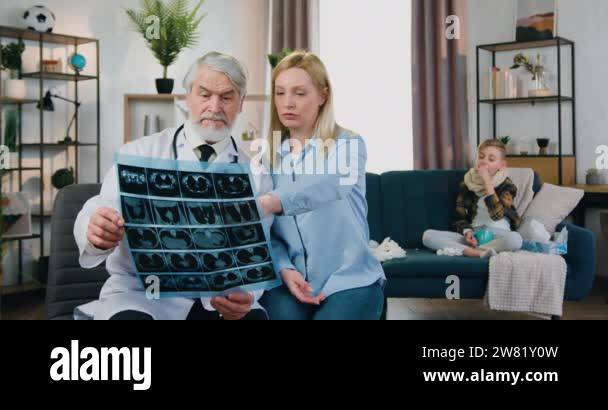 Cute sick exhausted boy with cough and sore throat sitting on the couch ...