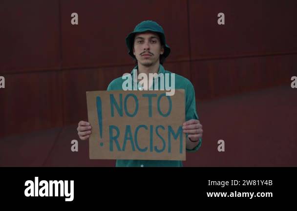 Male activist holding no to racism cardboard Stock Video Footage - Alamy