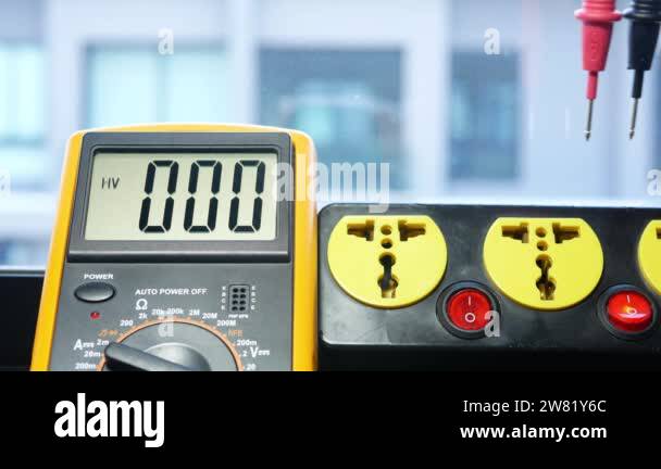 Measure the AC voltage of 230 Volts from the power outlet with a ...