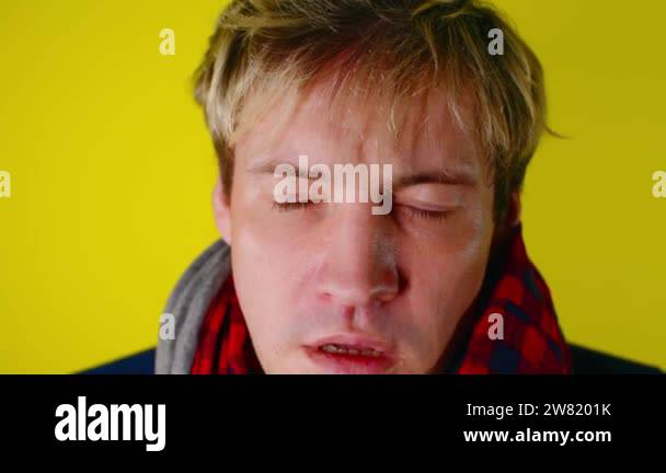 The man has a runny nose. Snot flows from the nose. A man has a cold ...