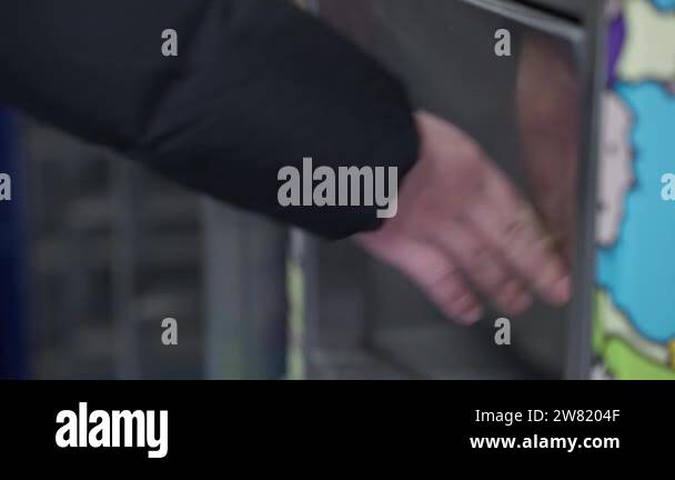 Close-up male Caucasian hand throwing disposable coffee cups in trash ...