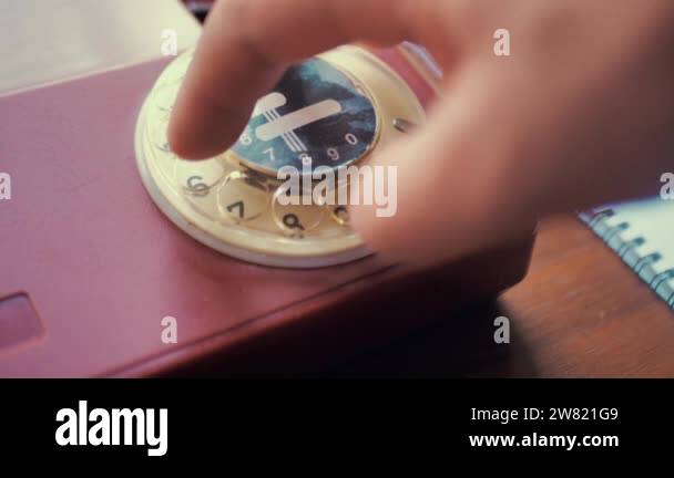 Ringing a red Rotary dial telephone. Dialing on an old rotary style ...