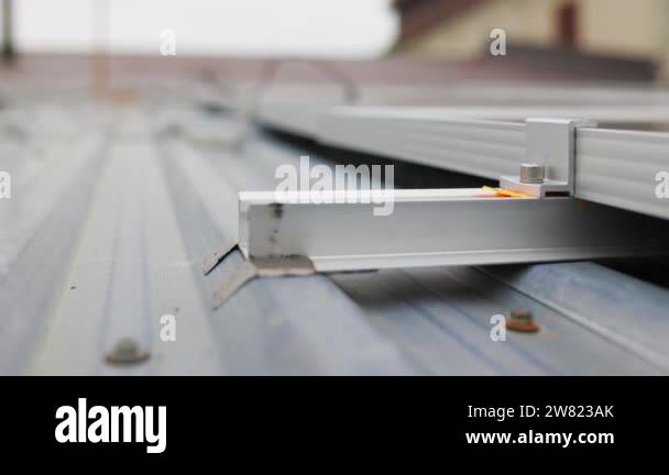 Close up of mounting solar panel, installing solar panels on the roof ...