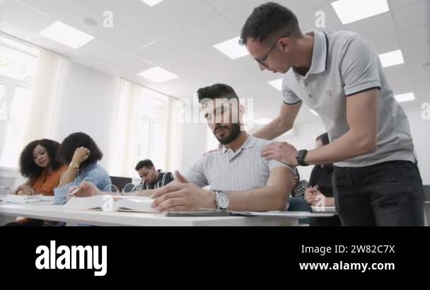 Multi ethnic group of students working on task together. Group of diversity college students ...