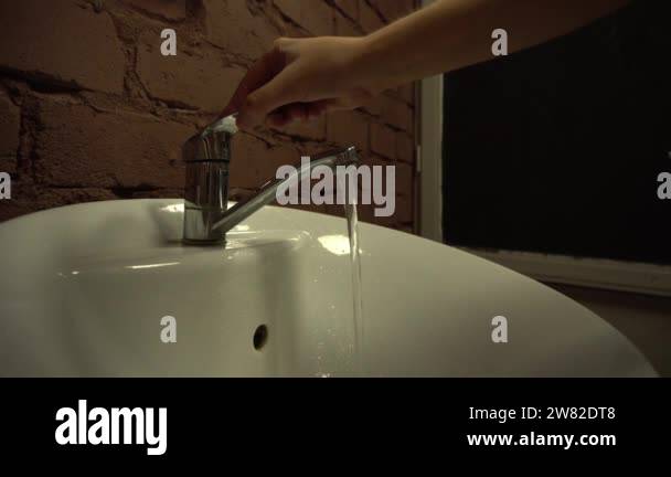 Washbasin in a restaurant, a guy washes his hands in a washbasin with ...