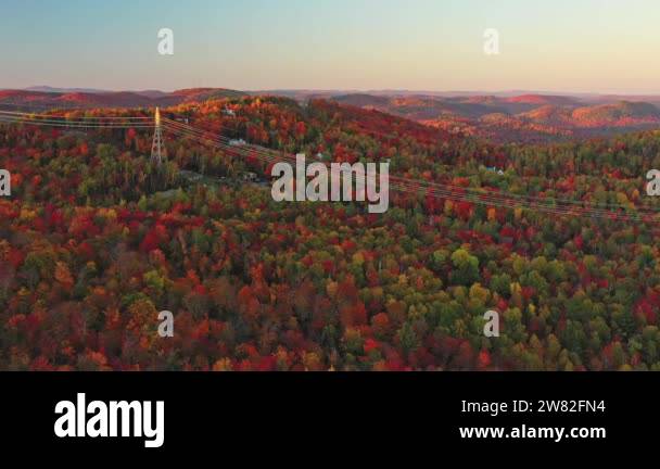 Flying slowly from right to left above the mountains at sunset showng ...