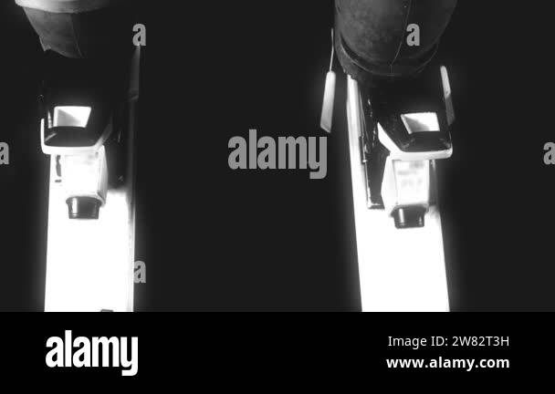 Skier attaching his ski boots, rear closing/opening of ski on black ...