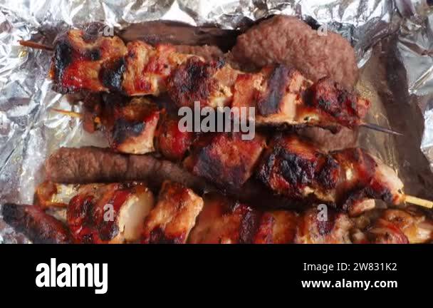 Grilled meat in disposable packaging and aluminum foil, delivered from ...