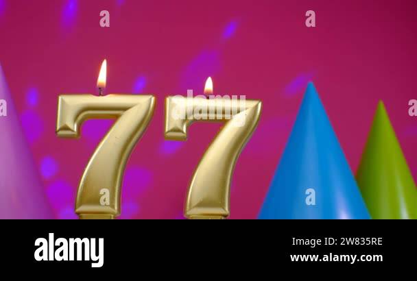 Burning birthday cake candle number 77. Happy Birthday background ...