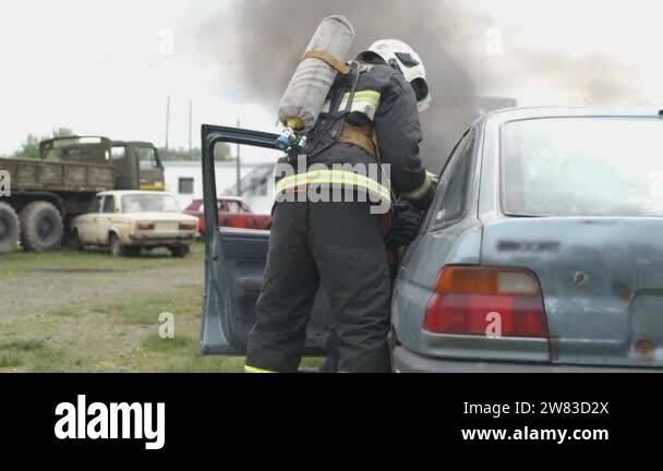 On the Car Crash Traffic Accident Scene: A fire rescue worker ...