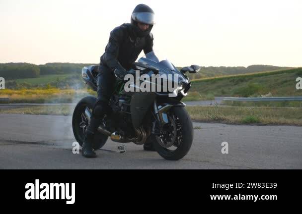Biker performing tire burnout with lots of smoke. Motorcycle wheel are ...
