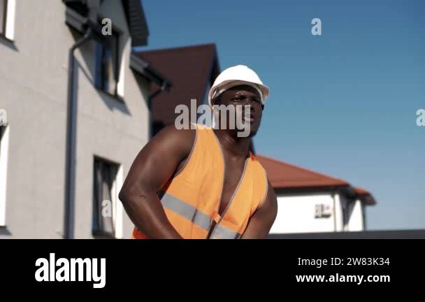 Muscular African American in uniform waving a sledgehammer at a ...