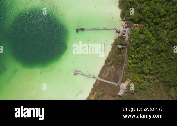 Aerial birds eye overhead top down descending view of people swimming ...