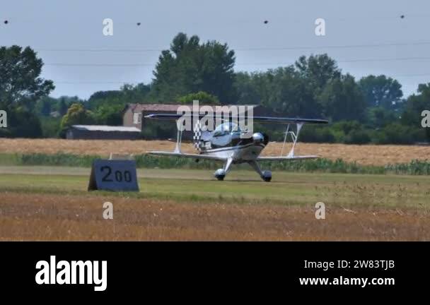 Extreme aerobatic retro biplane takes off and pull up Stock Video ...