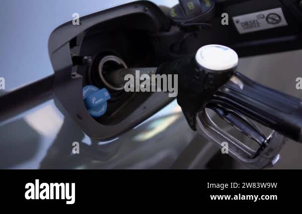 Man hand holding fuel pistols to filling up his car tank filler flap at ...