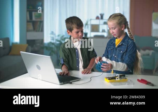 computer programming of technology by children, little boy and girl ...